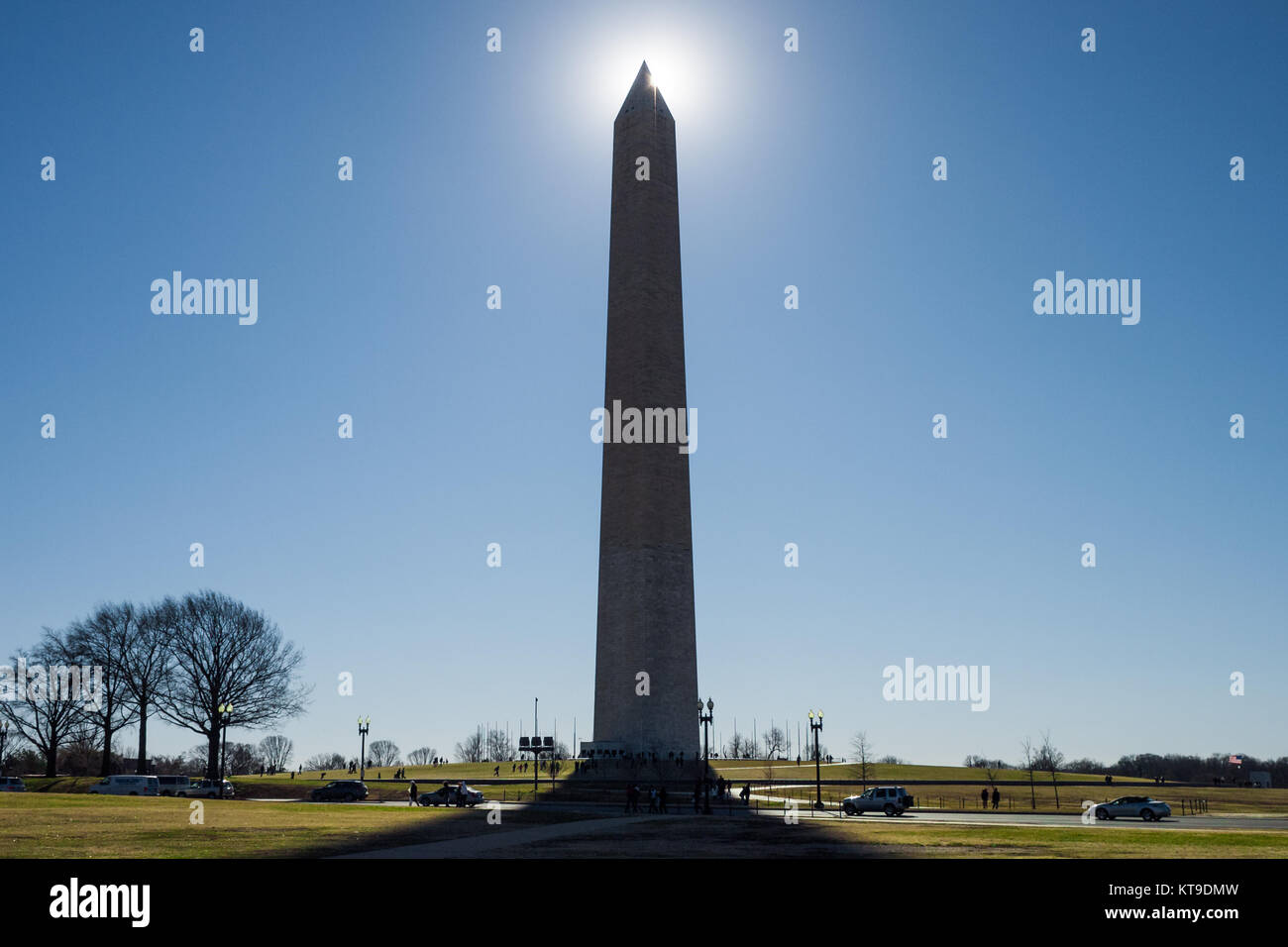 Washington Monument and sun casting a shadow on a clear blue sky day ...