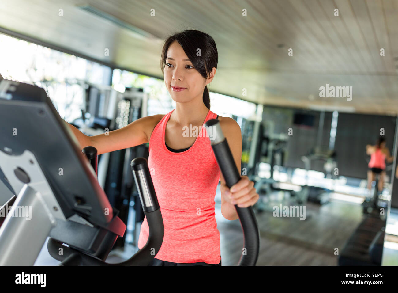 Woman training on Elliptical machine Stock Photo - Alamy