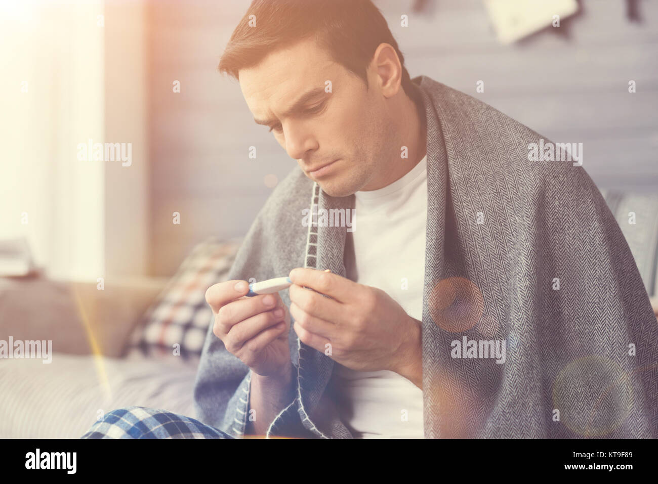 Probably fever. Concerned ill careful guy checking his symptoms and ...