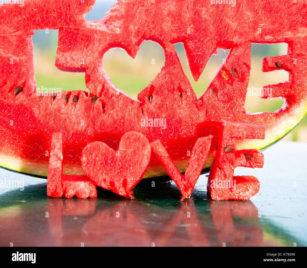 Fresh juicy watermelon slice with love letters word on table Stock ...