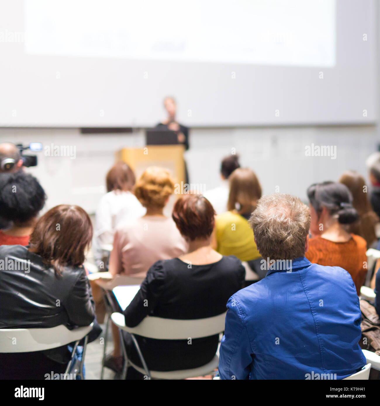 Woman giving presentation in lecture hall at university Stock Photo - Alamy