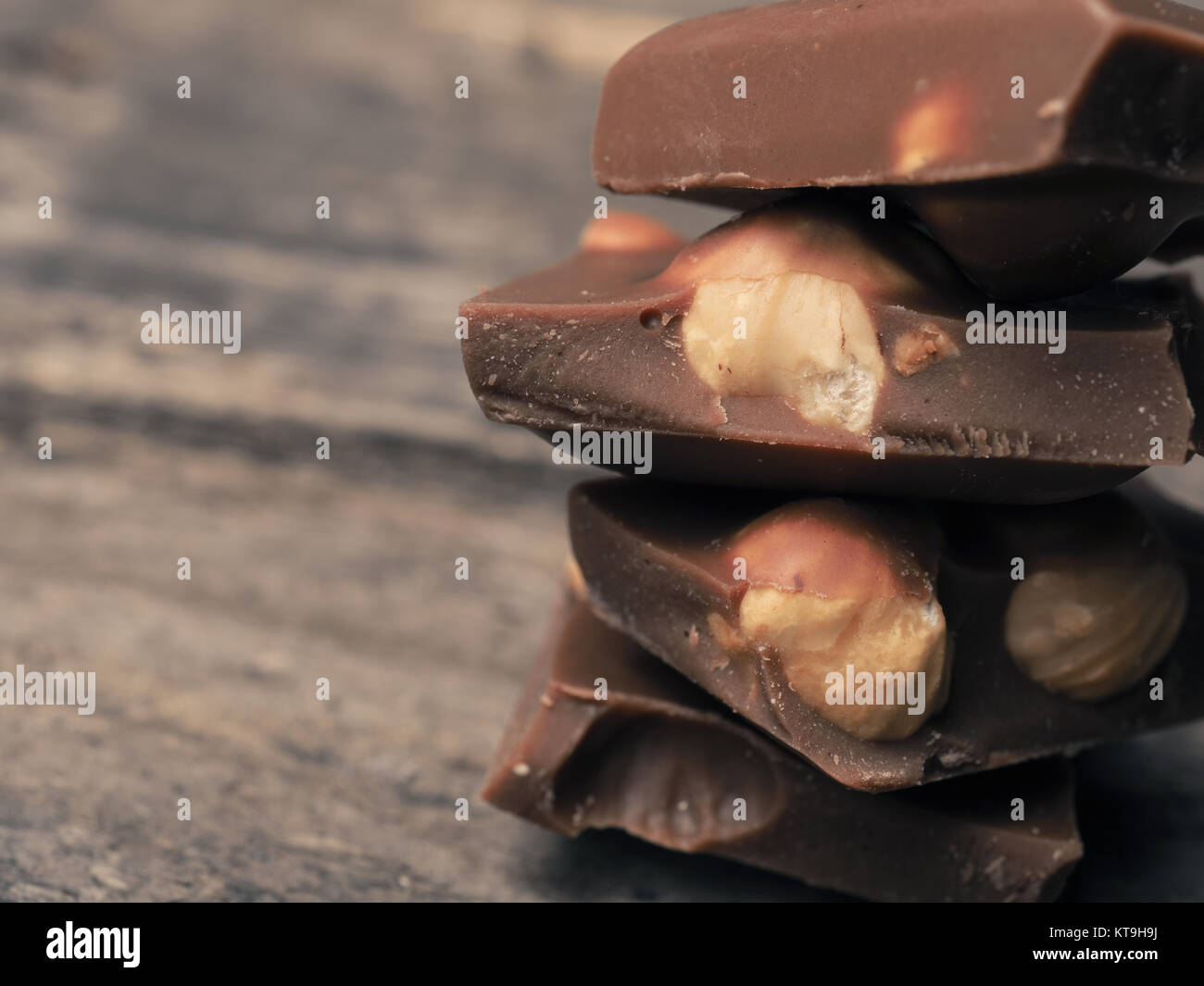 Close up of stacked chocolate bars on a wooden table, vintage color ...