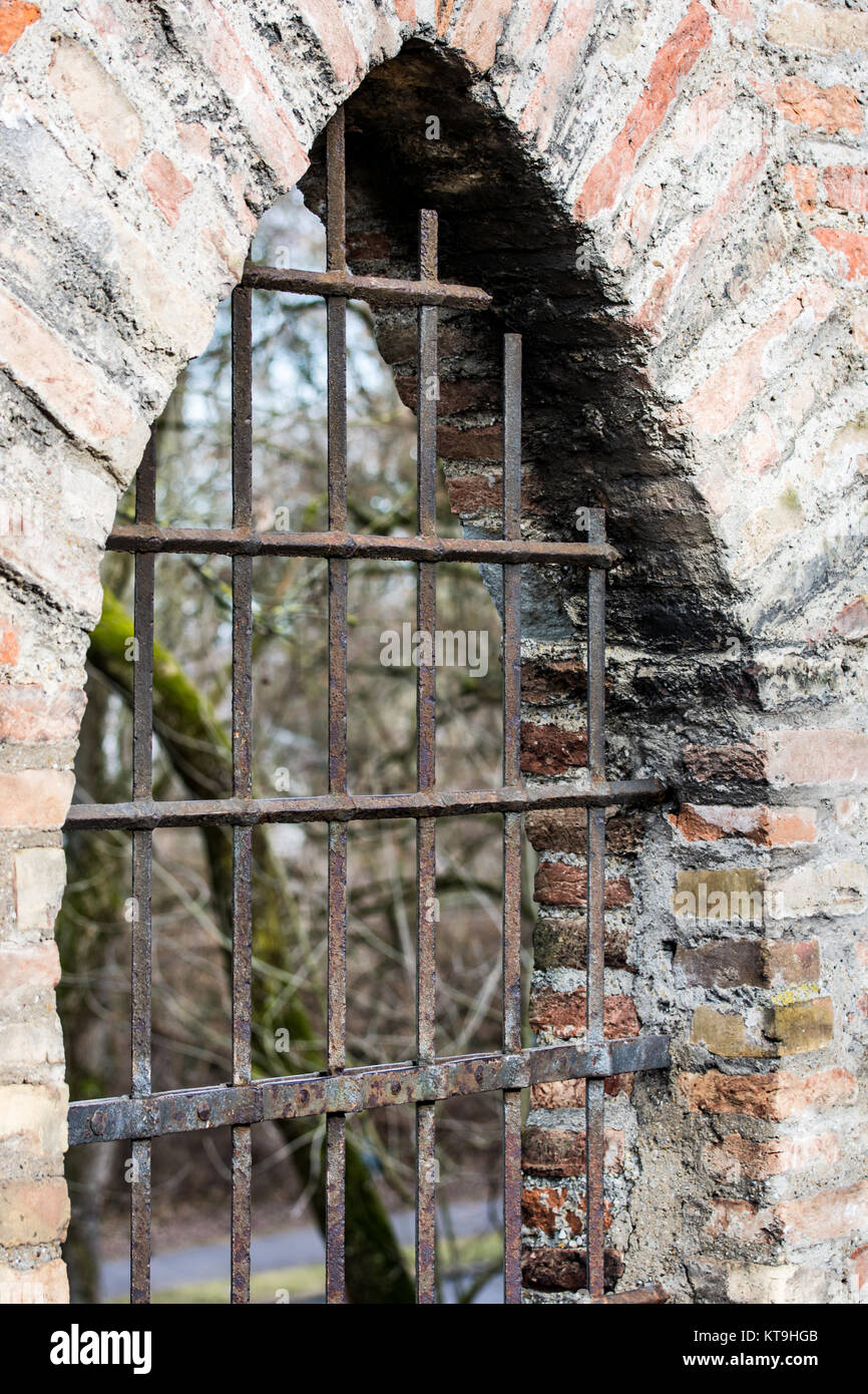 Barred window in a historic city wall Stock Photo - Alamy