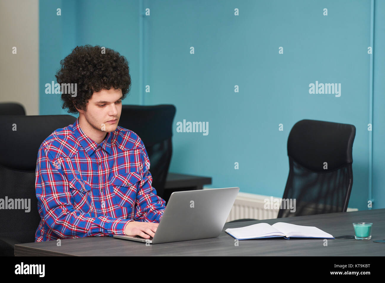 Young adult working on laptop Stock Photo - Alamy