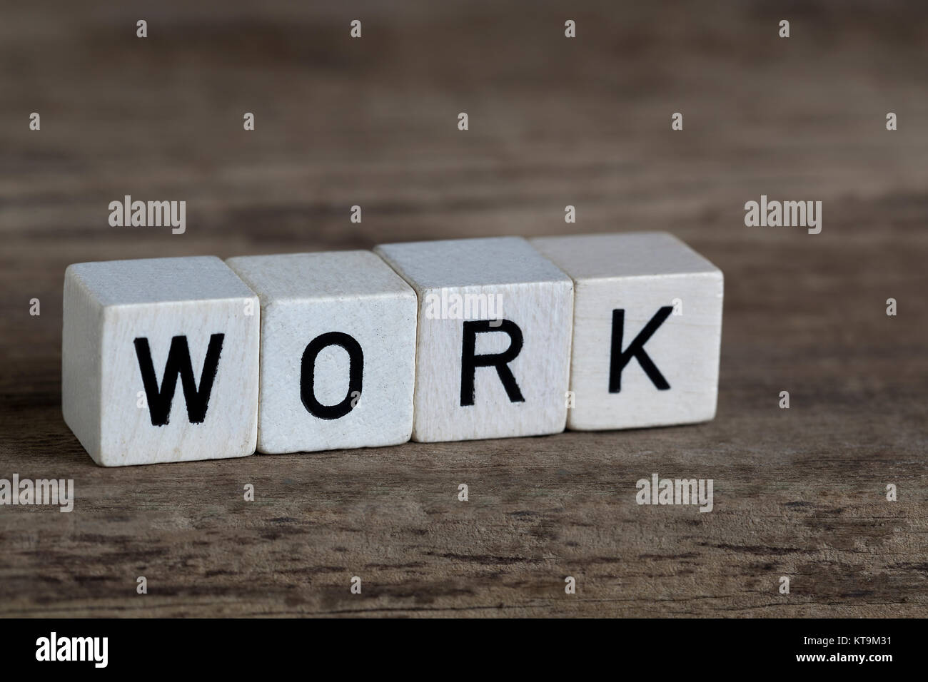 Work, written in cubes on a wooden background Stock Photo - Alamy
