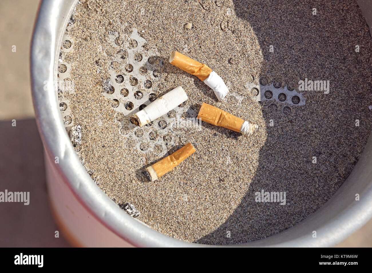 Used cigarettes in an ashtray Stock Photo - Alamy