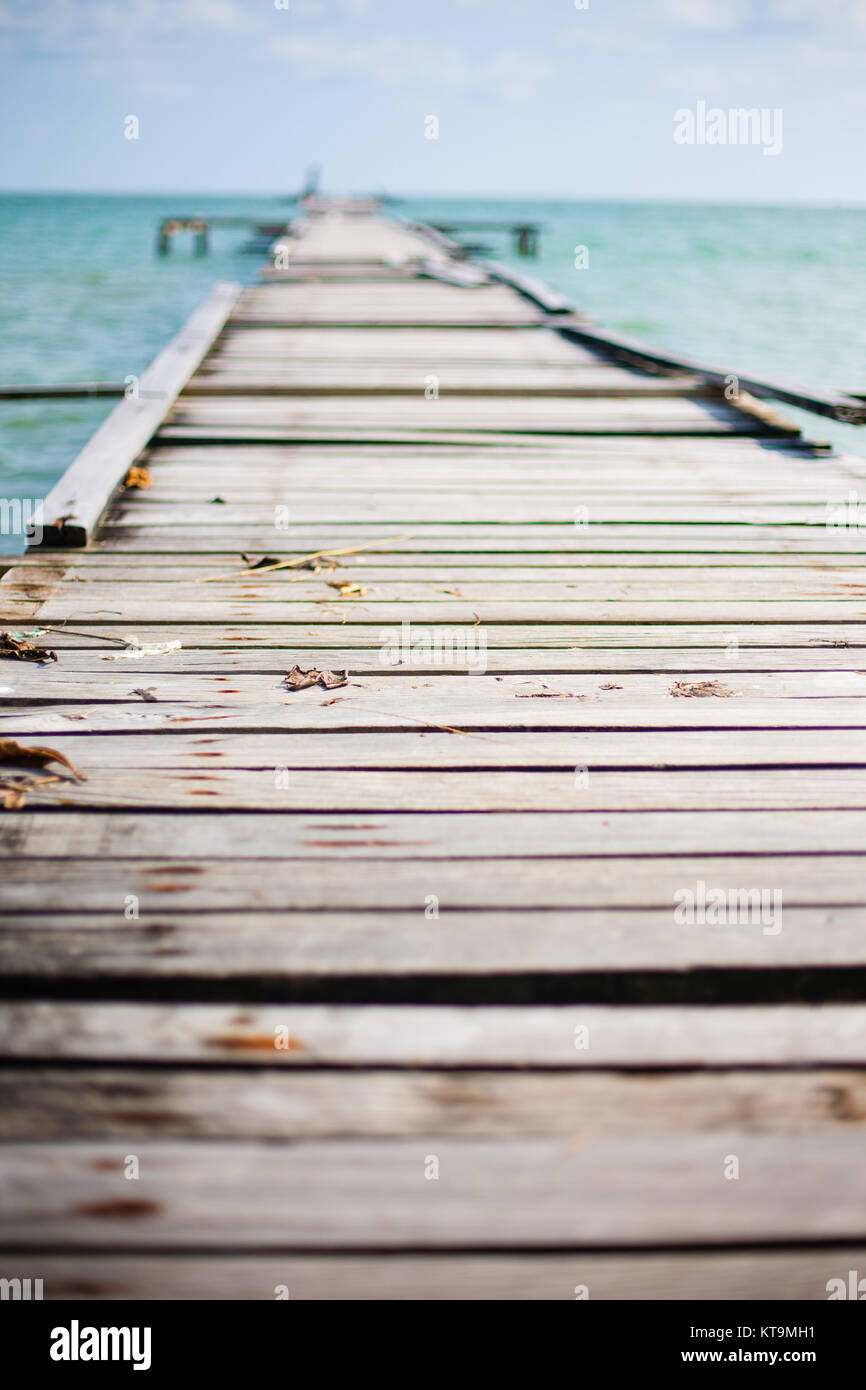 Wooden pier on the sea background Stock Photo - Alamy