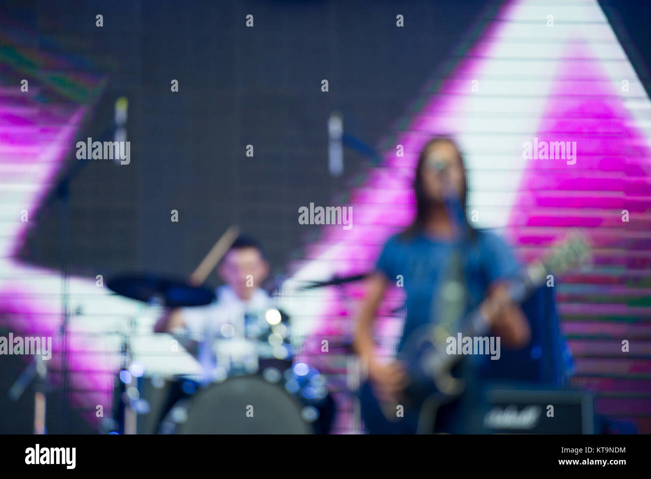 Abstraction of concert stage with blurry musicians during rock concert ...