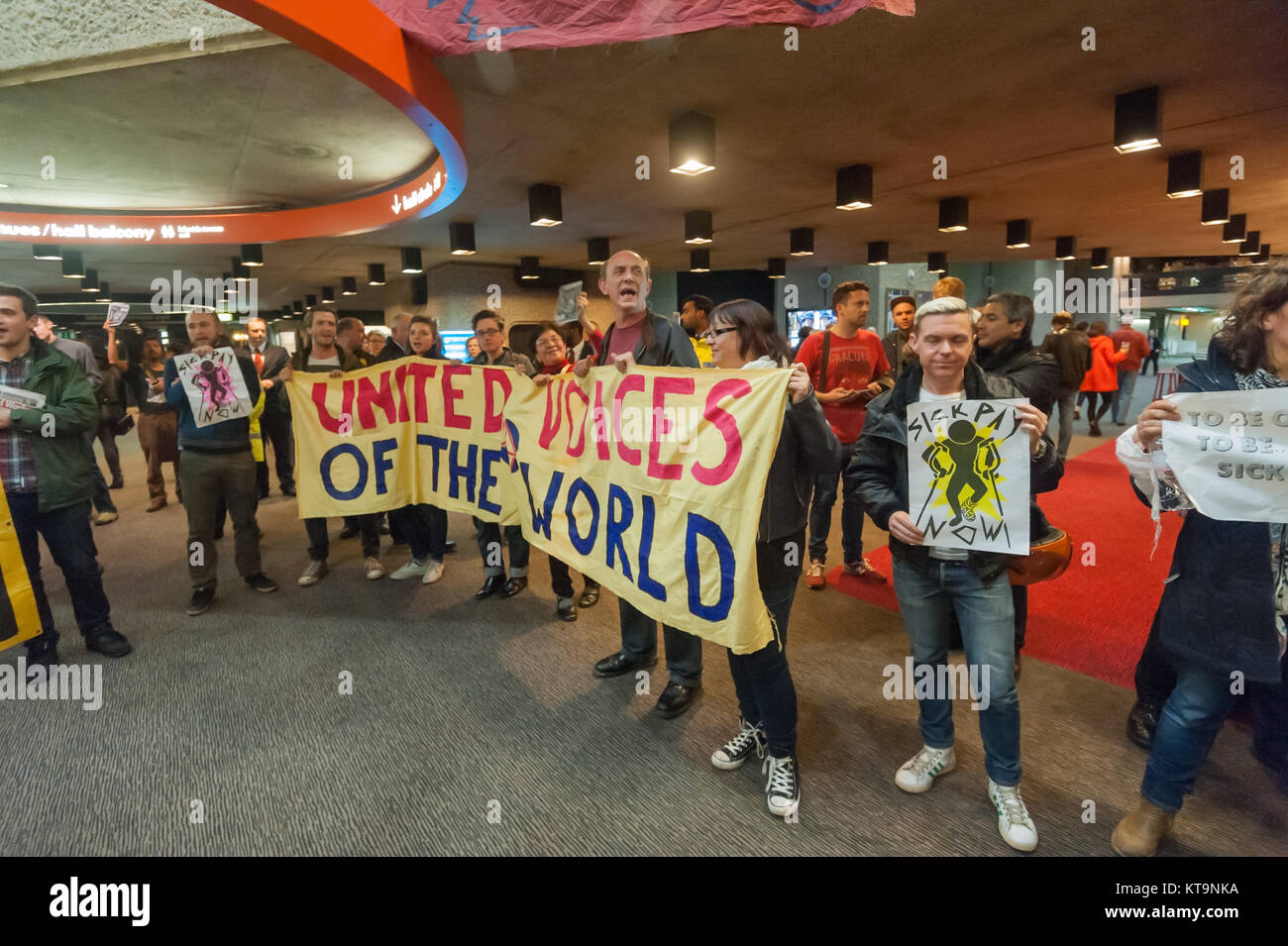 People hold the United Voices of the World banner at UVW cleaners ...