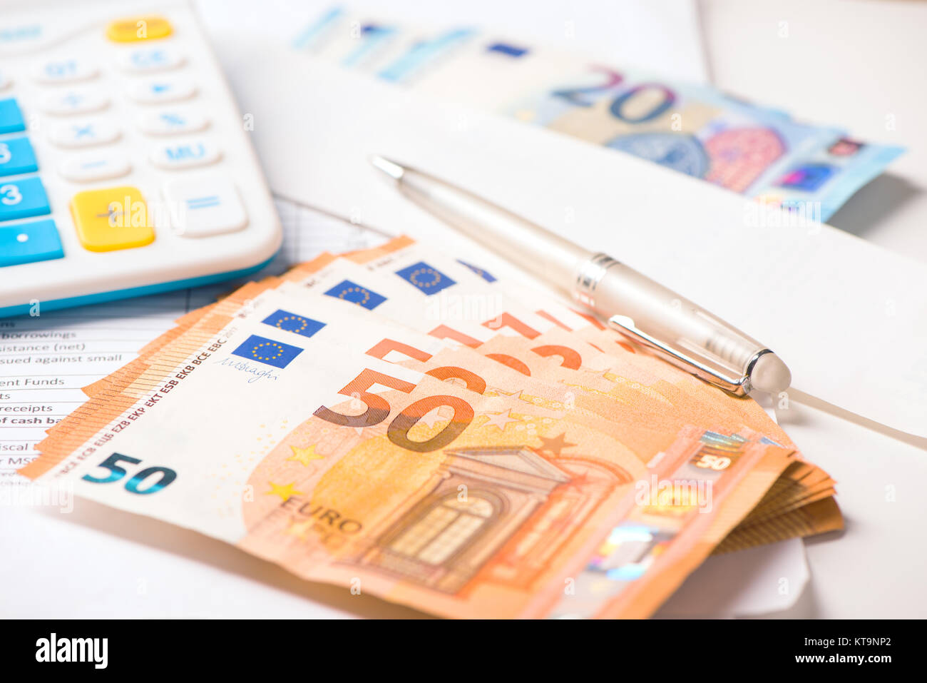 Calculator and euro money on a table desk Stock Photo - Alamy