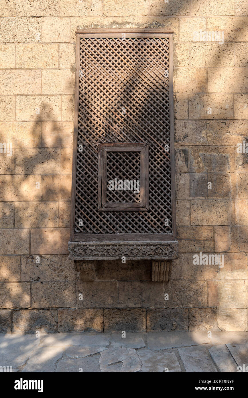 Ancient grunge wall with oriel window covered by interleaved wooden ...