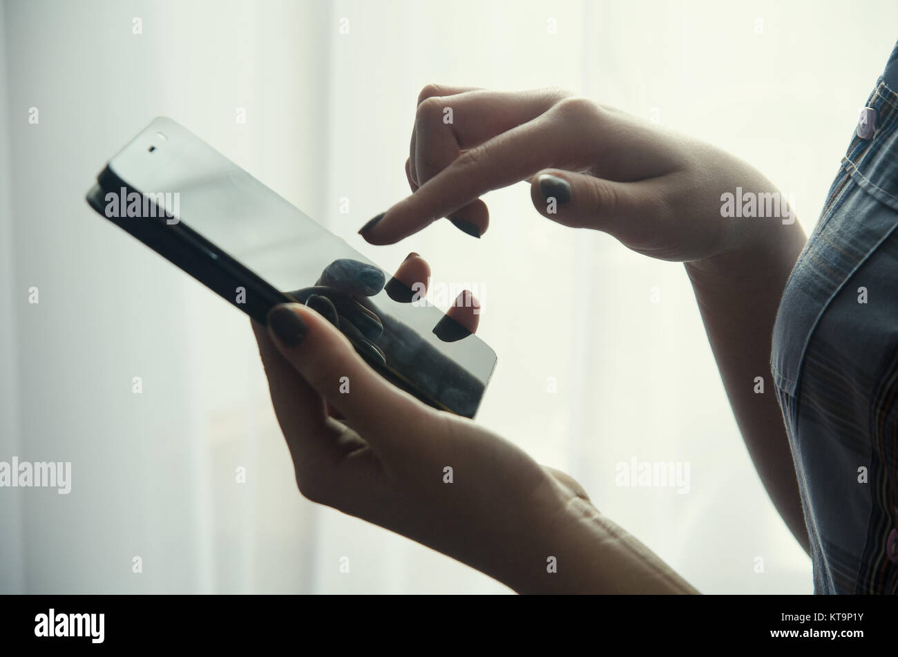 Female hands hold the smartphone and press Stock Photo - Alamy