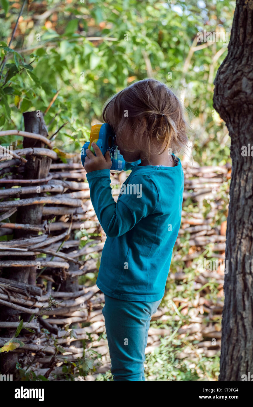 Little girl with a toy camera in the creative process Stock Photo - Alamy