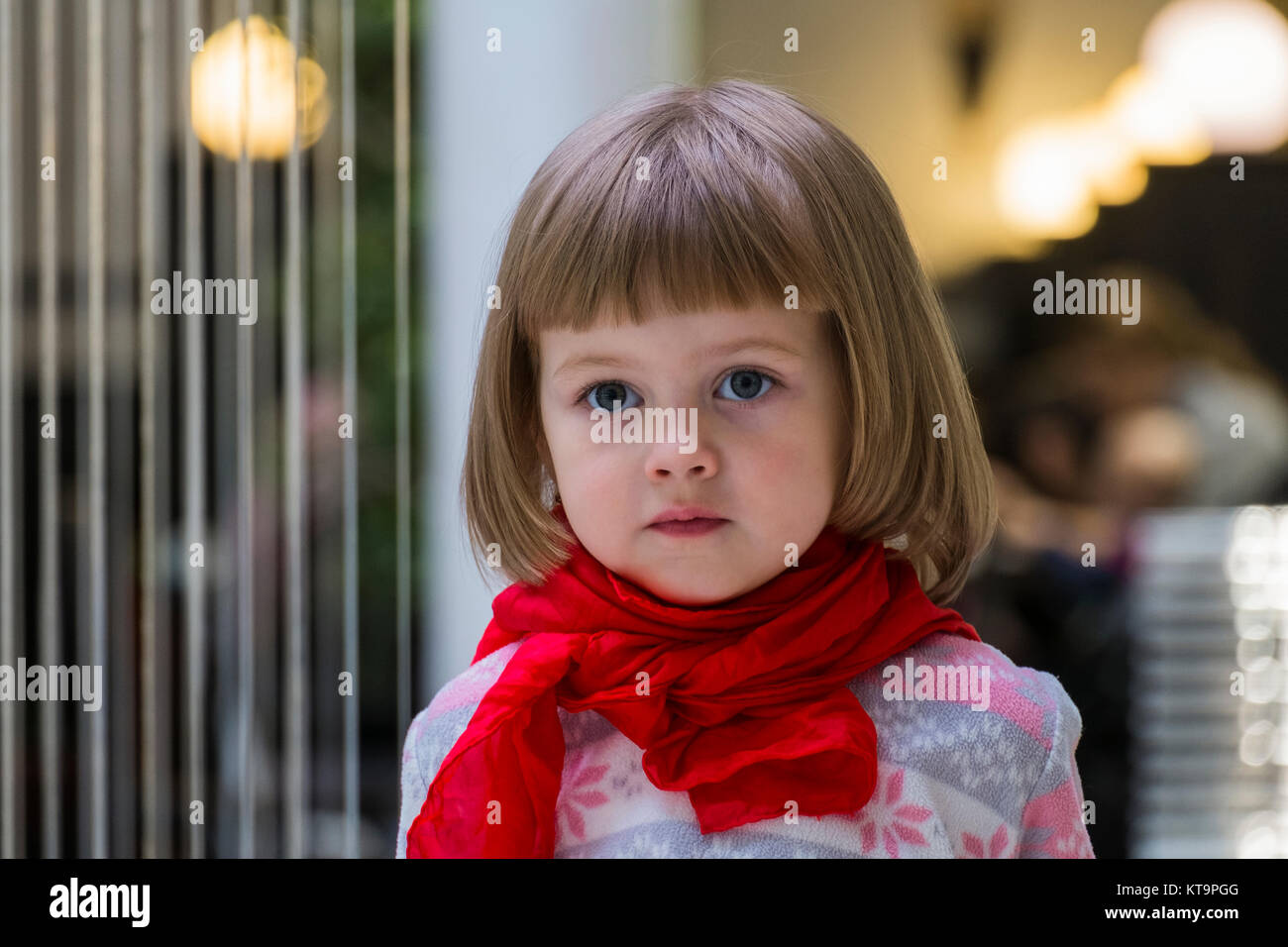 Portrait of a little girl in a red scarf Stock Photo - Alamy