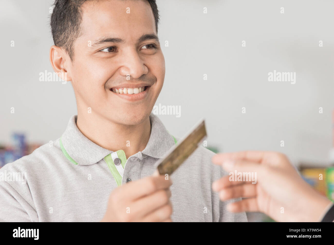 male customer paying his bills with credit card at the cashier in ...