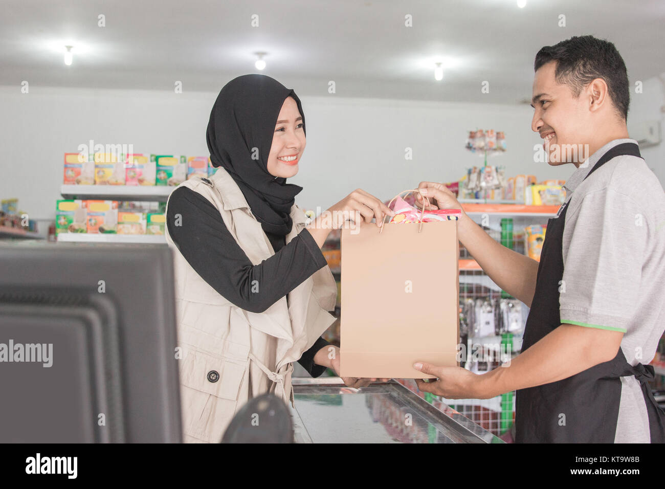happy muslim woman buying product at grocery store or supermarket Stock ...