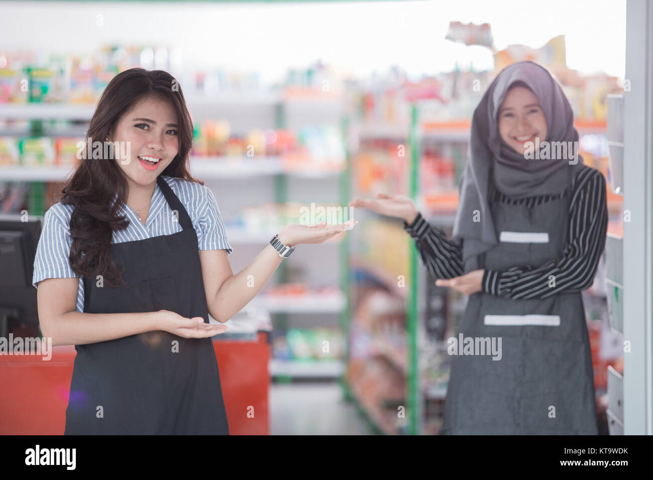 Portrait of smiling asian female staff welcoming customer in ...