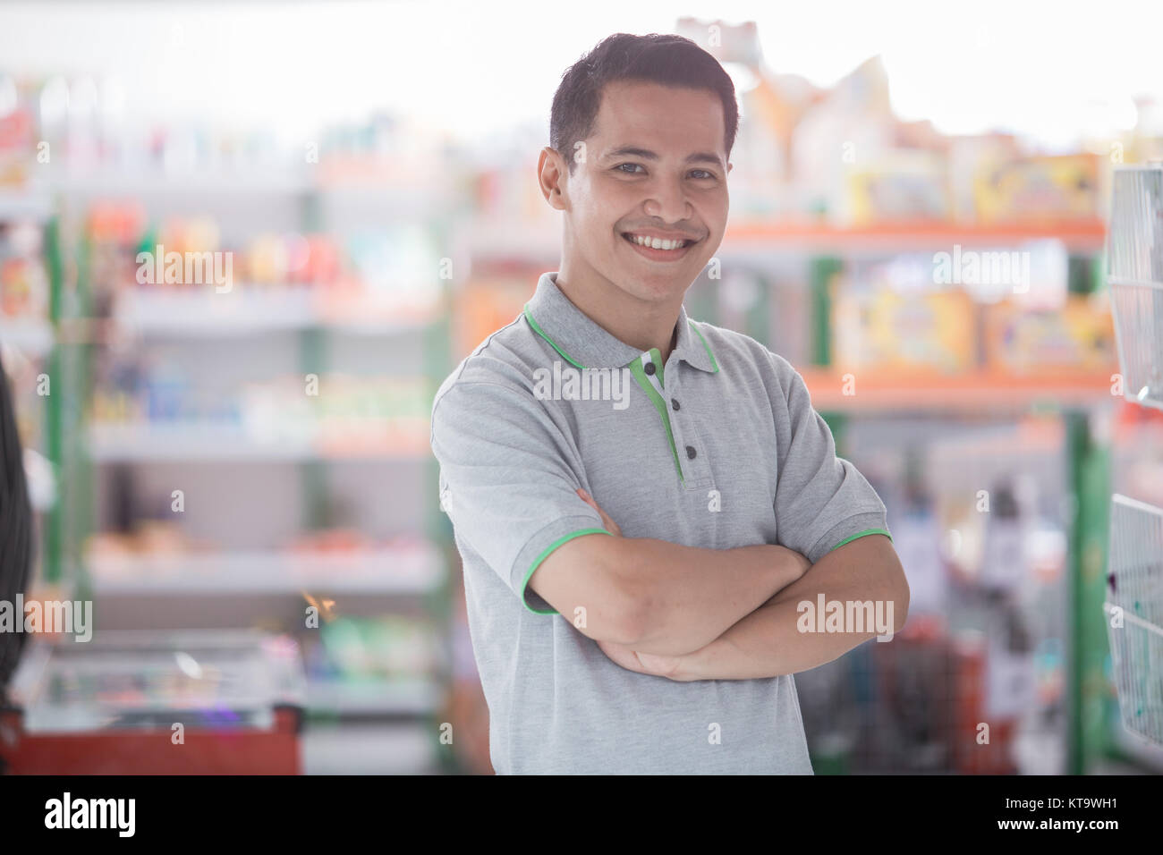 success supermarket owner standing in front of his shop Stock Photo - Alamy