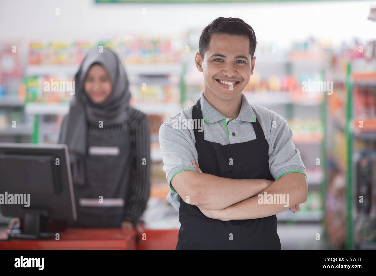 success supermarket owner standing in front of his shop Stock Photo - Alamy