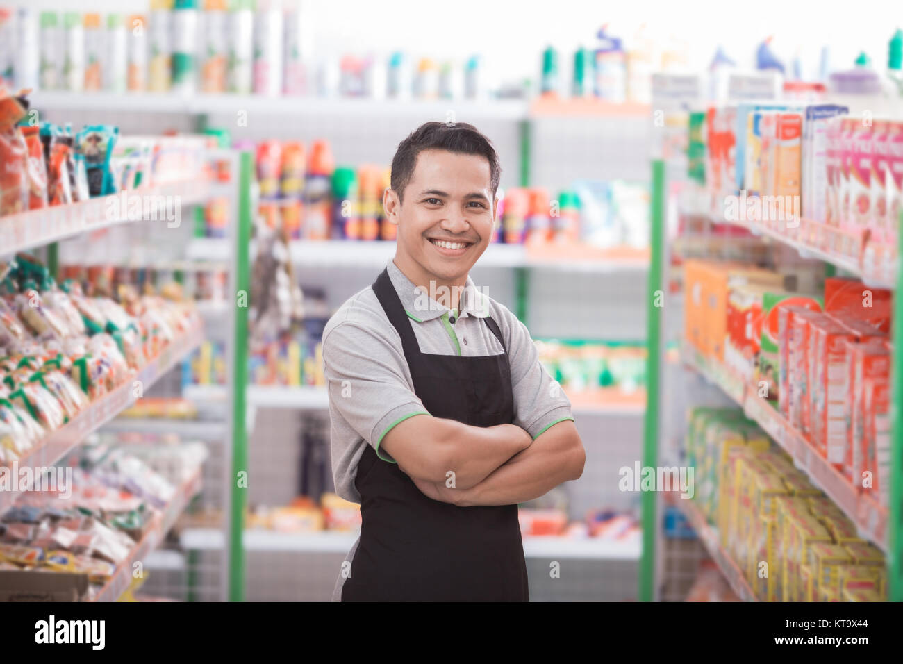 asian male shopkeeper standing in front of the groceries store Stock ...