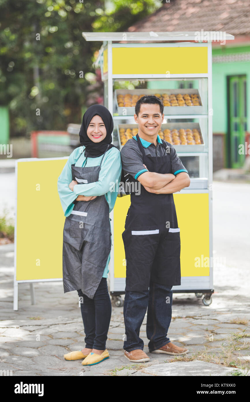 muslim woman and man small business owner standing proudly in front of ...