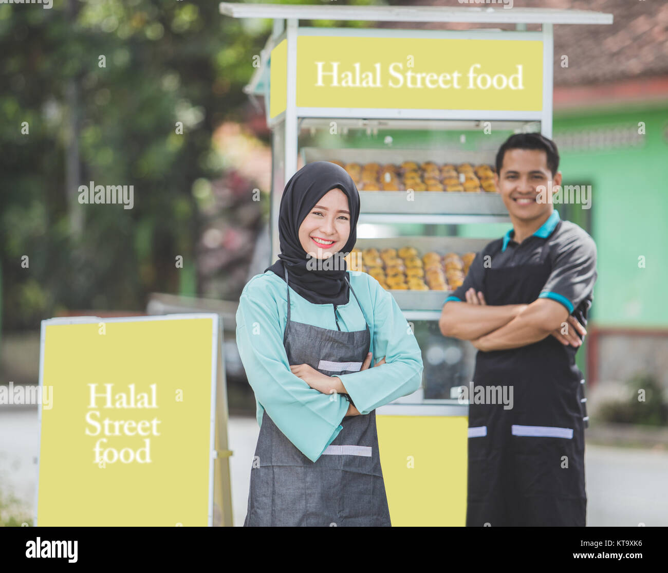young asian muslim small food stall owner, standing proudly with her ...