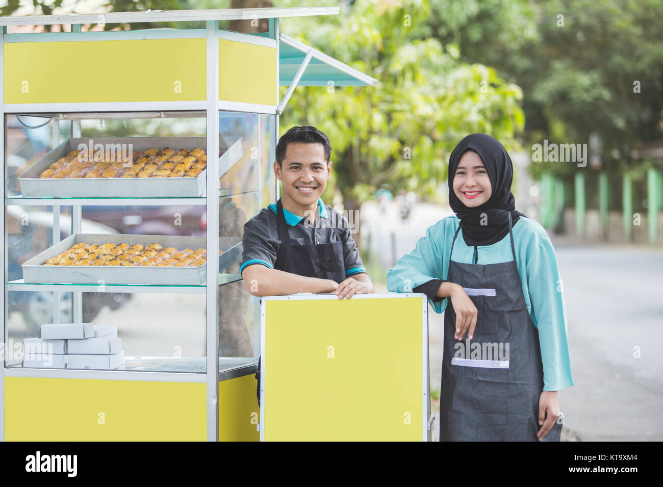 muslim woman and man small business owner standing proudly in front of ...