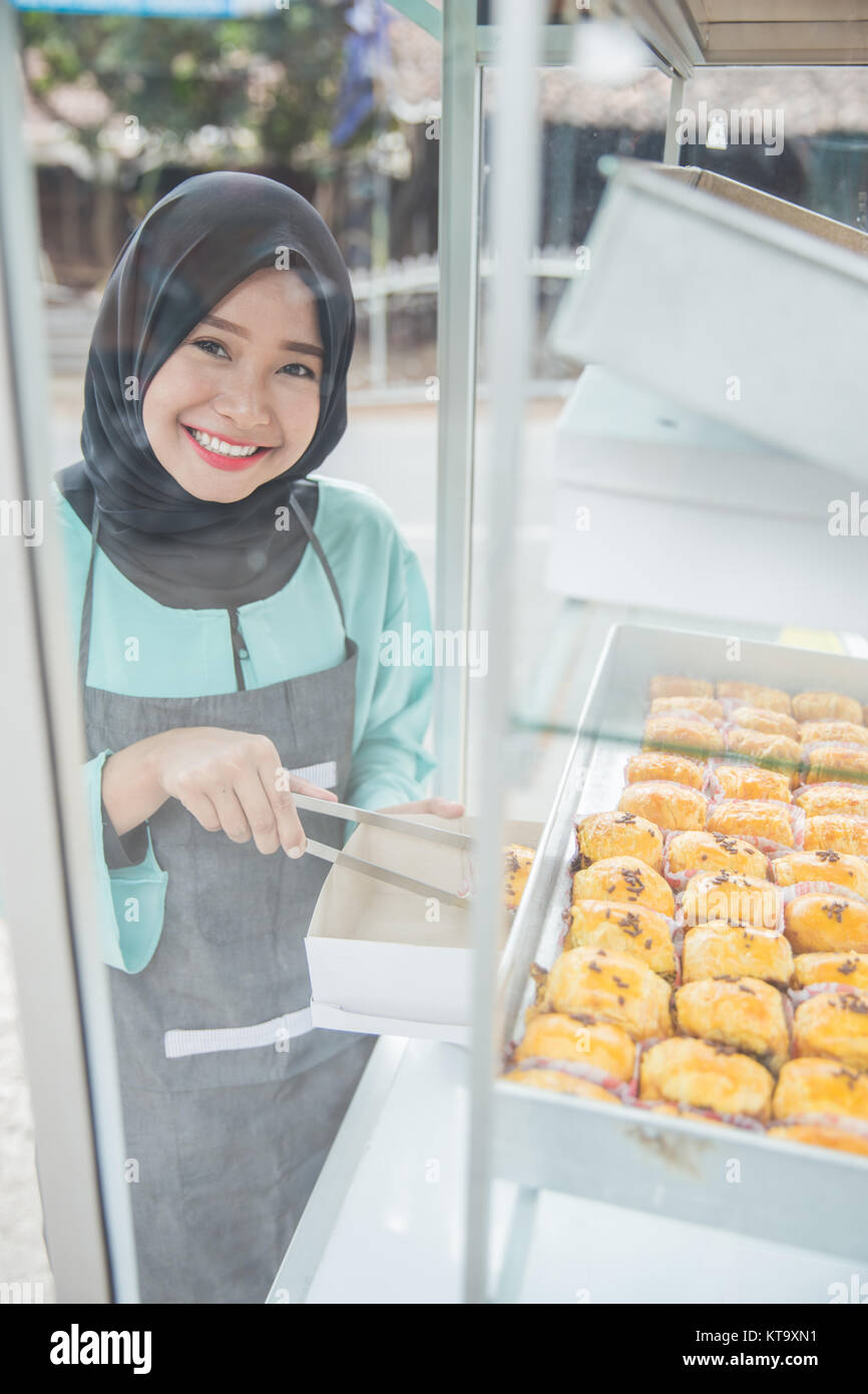 young muslim entrepreneur with her small business food stall. halal ...
