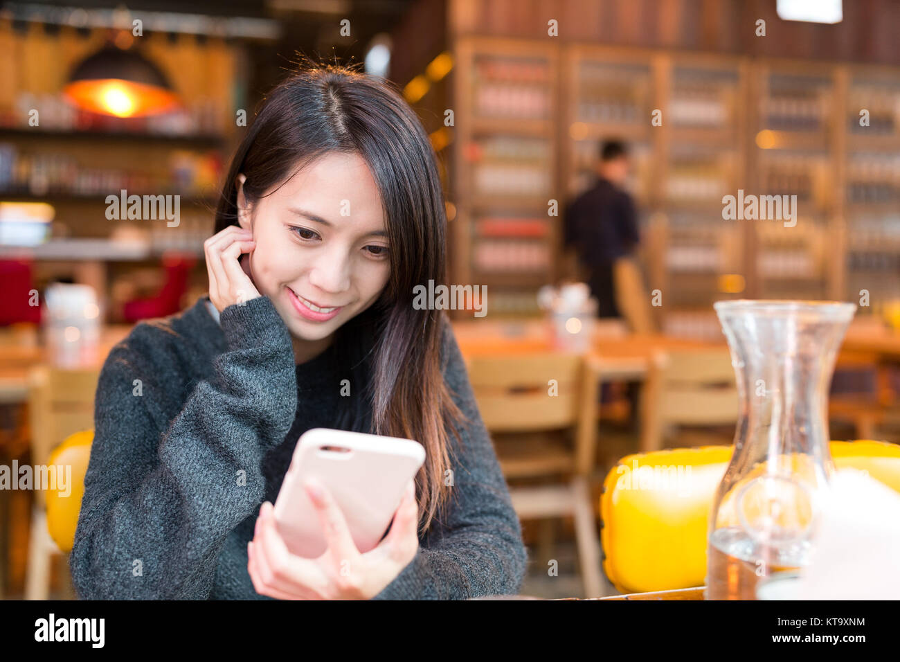 Woman using of cellphone in restaurant Stock Photo - Alamy