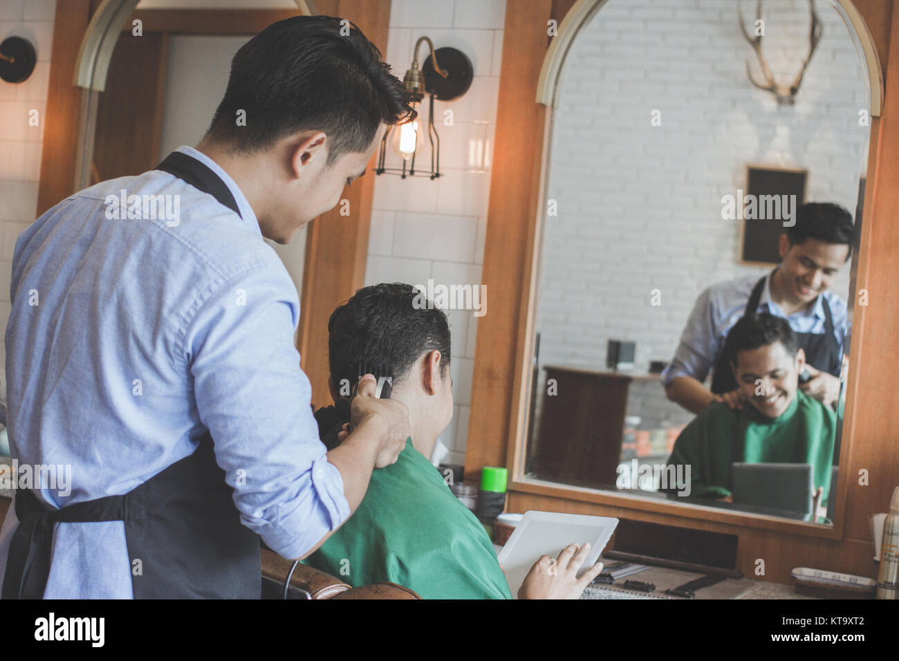 Barber making haircut attractive man hi-res stock photography and ...