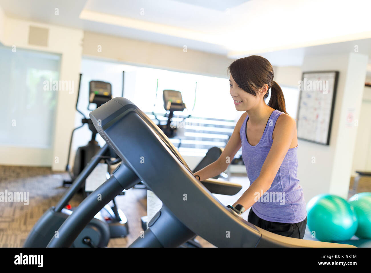 Woman running on treadmill Stock Photo - Alamy