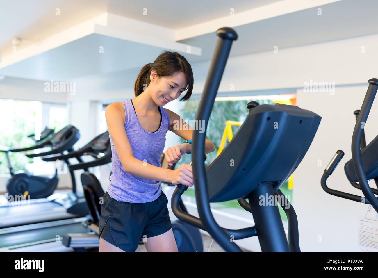 Asian girl on cross trainer hi-res stock photography and images - Alamy