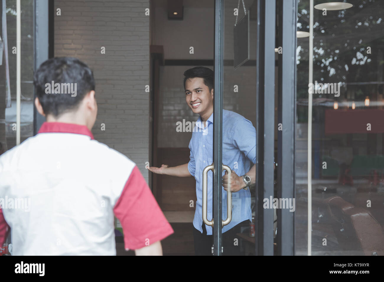 Confident young barber expert smiling welcoming customer to his ... Confident young barber expert smiling welcoming customer to his ...