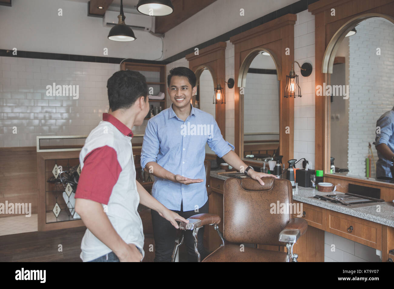 Confident young barber expert smiling welcoming customer to his ...