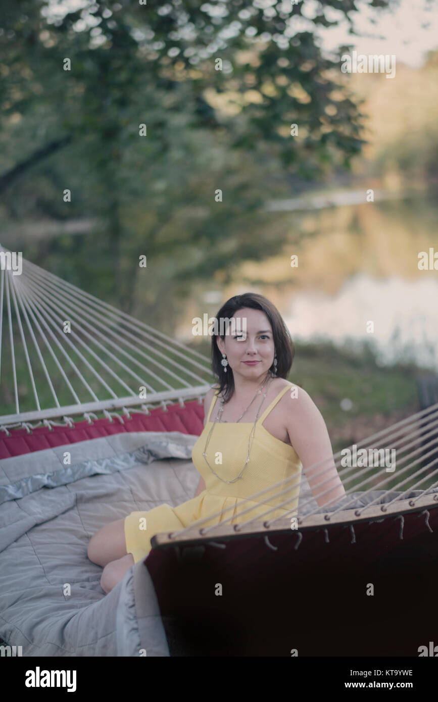 woman outdoors in a hammock with a creek behind her Stock Photo - Alamy
