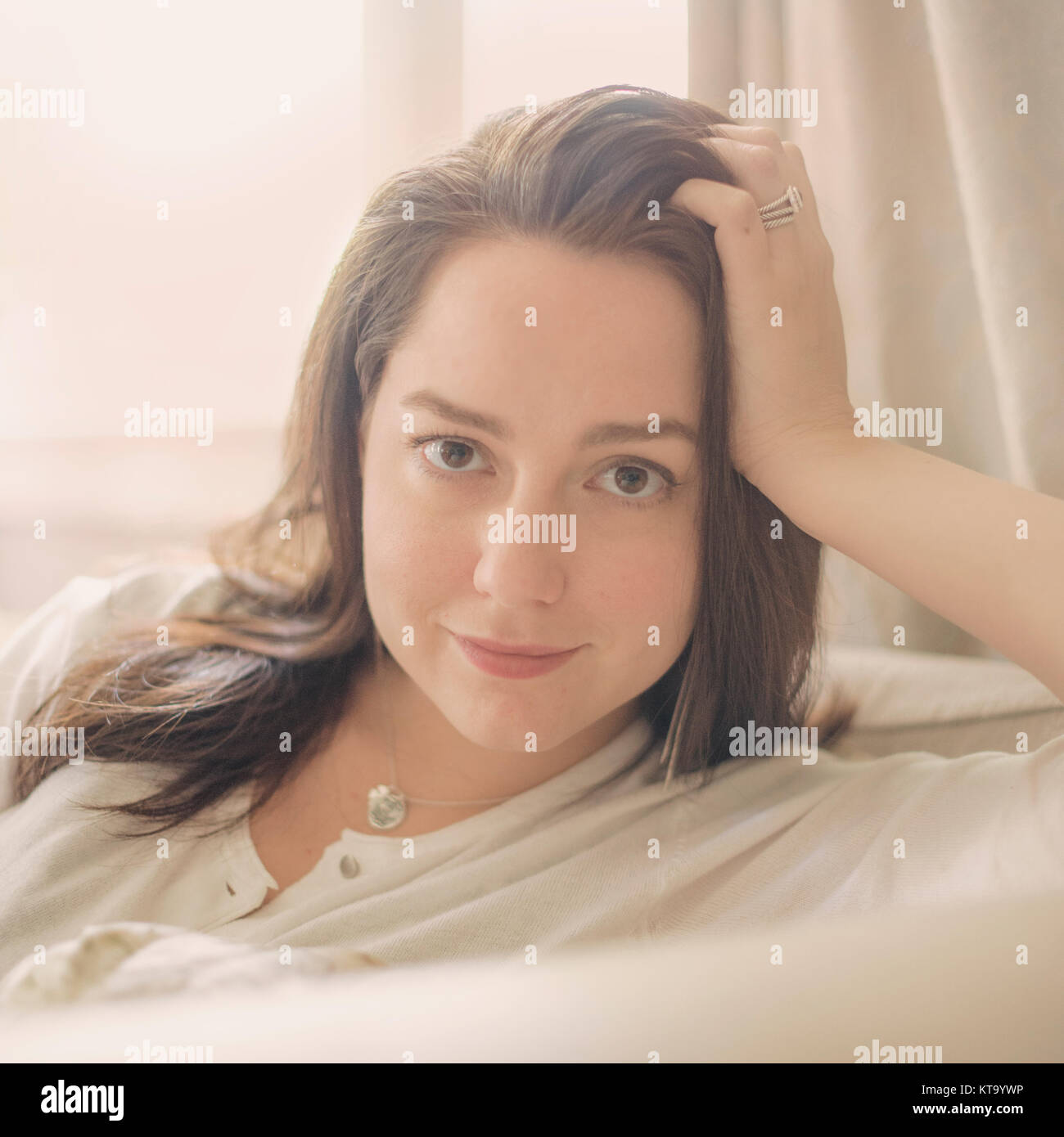pretty young woman looking into the camera Stock Photo - Alamy