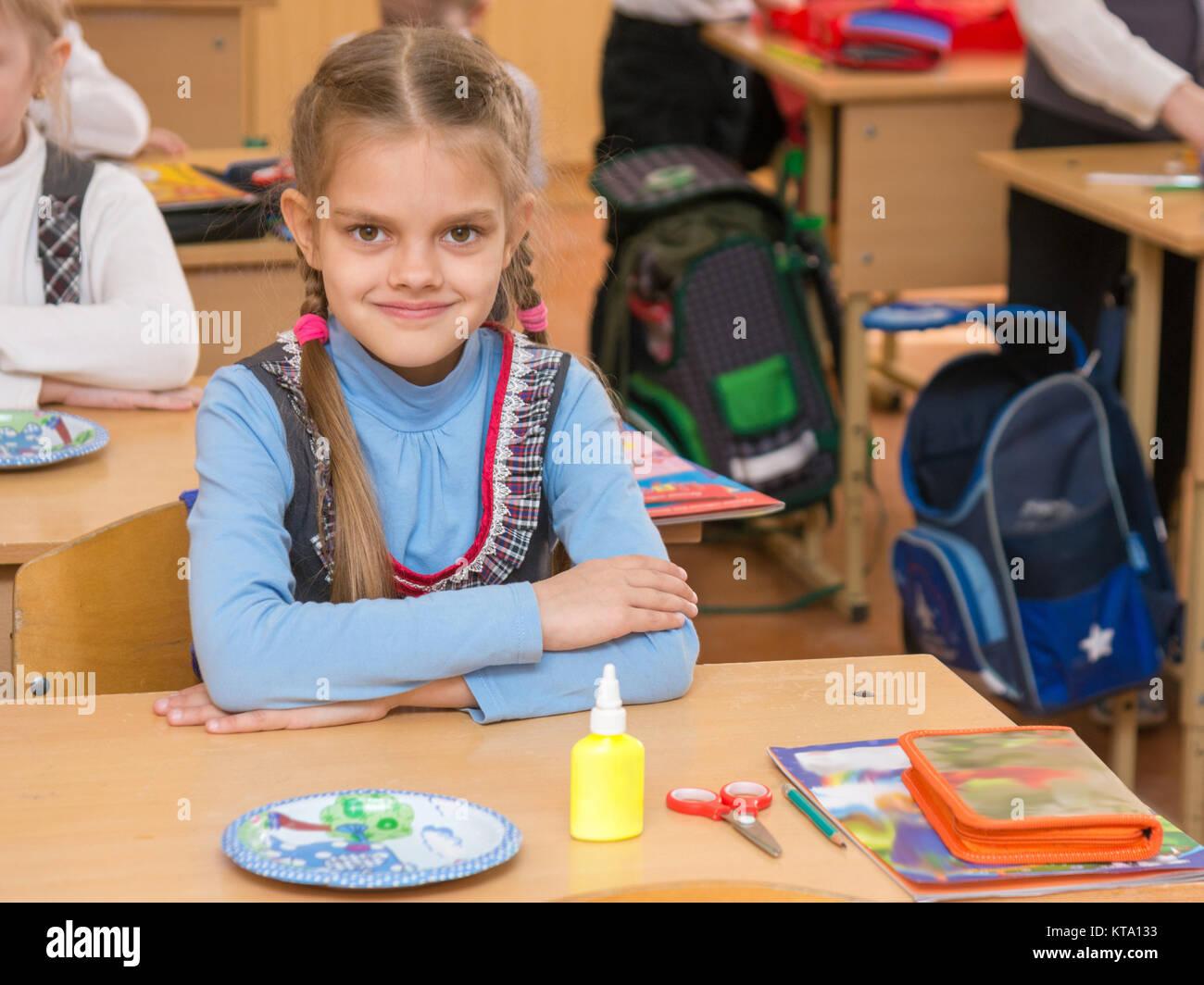 Happy first grader at a lesson in the school of technology, look in the ...