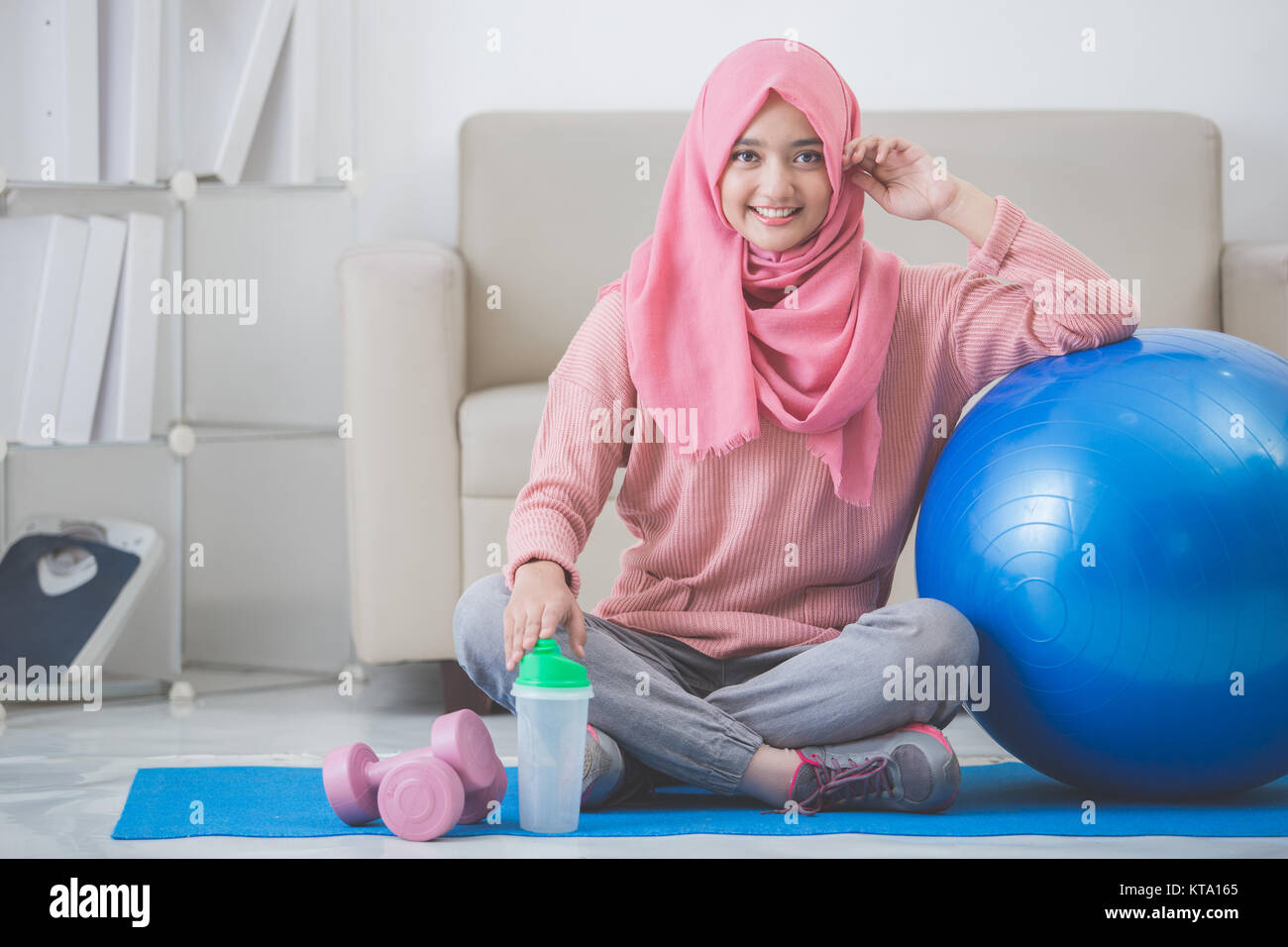 healthy asian muslim woman with hijab doing exercise at home Stock ...