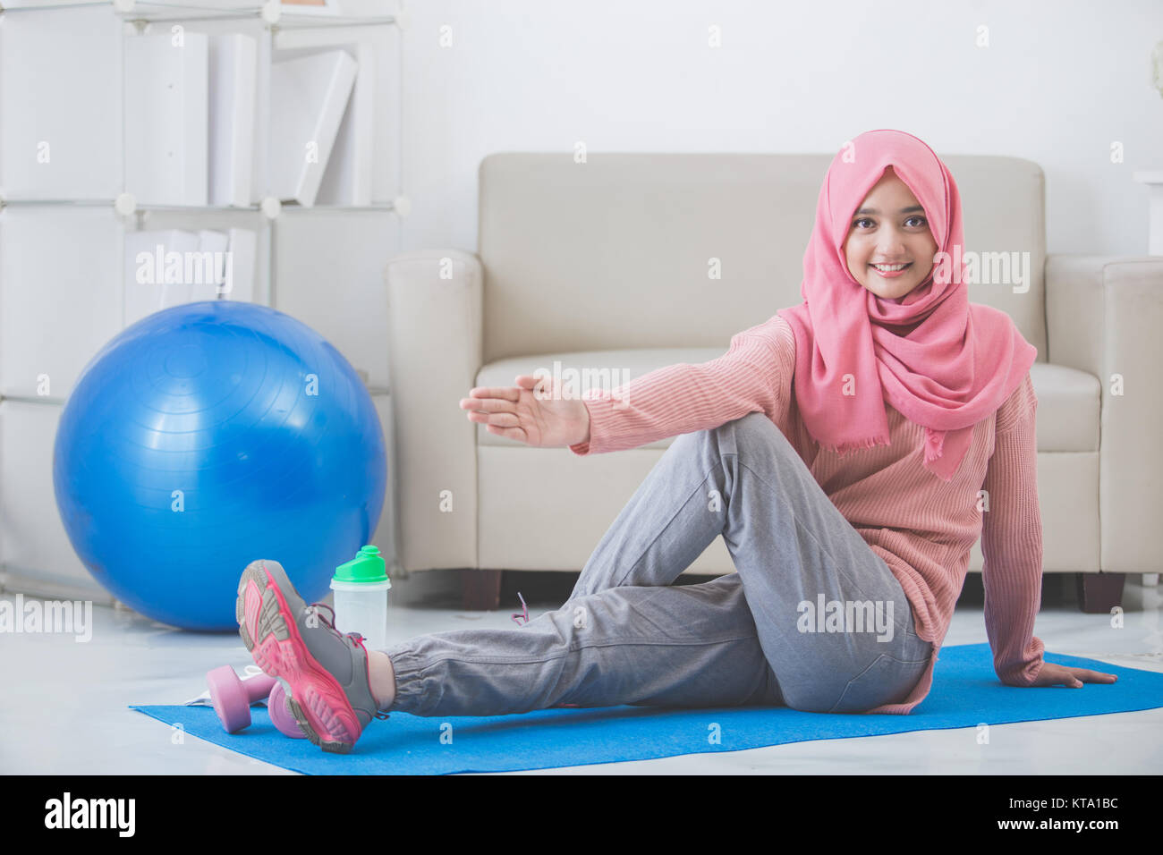 healthy asian muslim woman stretching while doing exercise at home ...