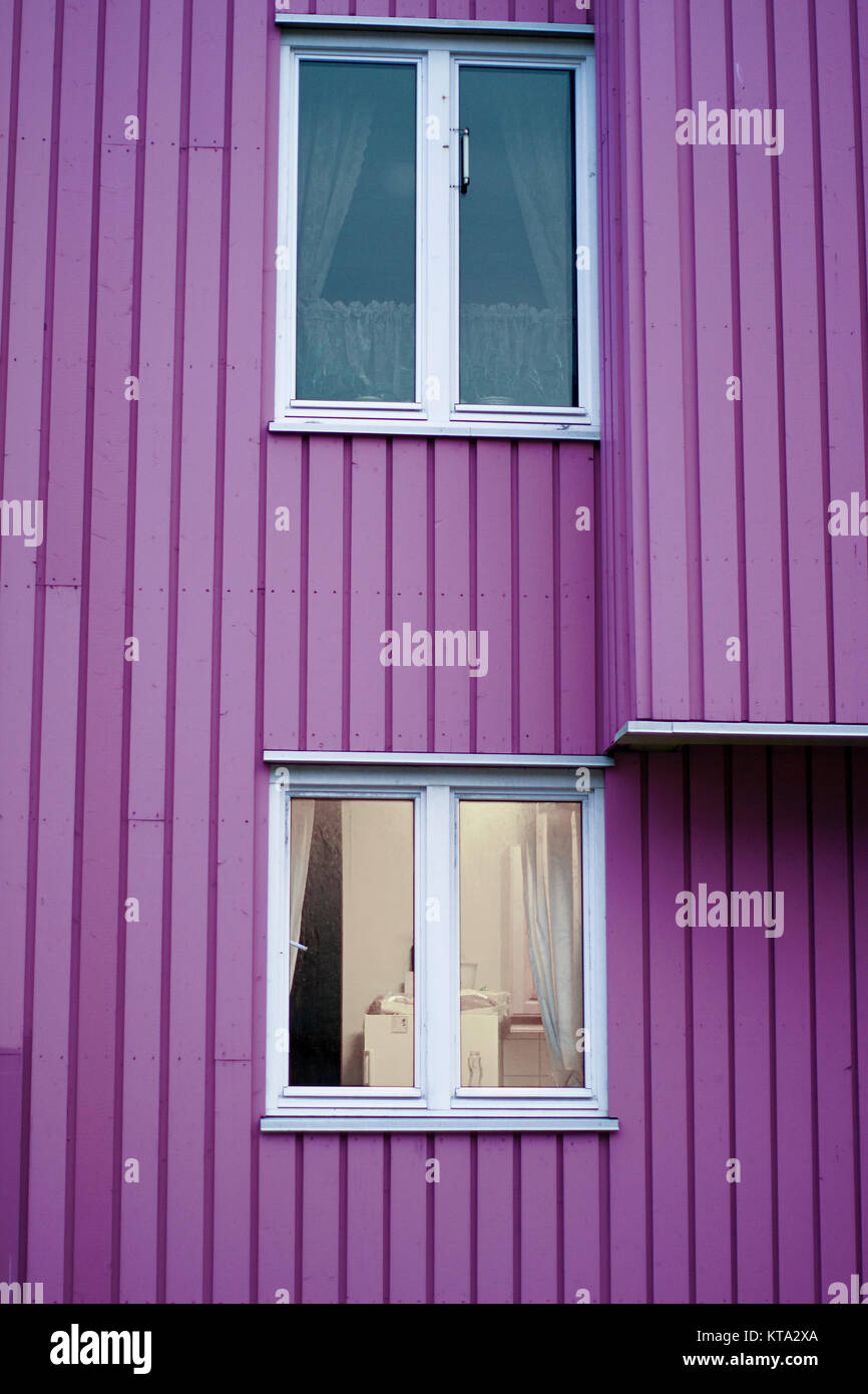 purple wall wooden house two white windows Stock Photo - Alamy