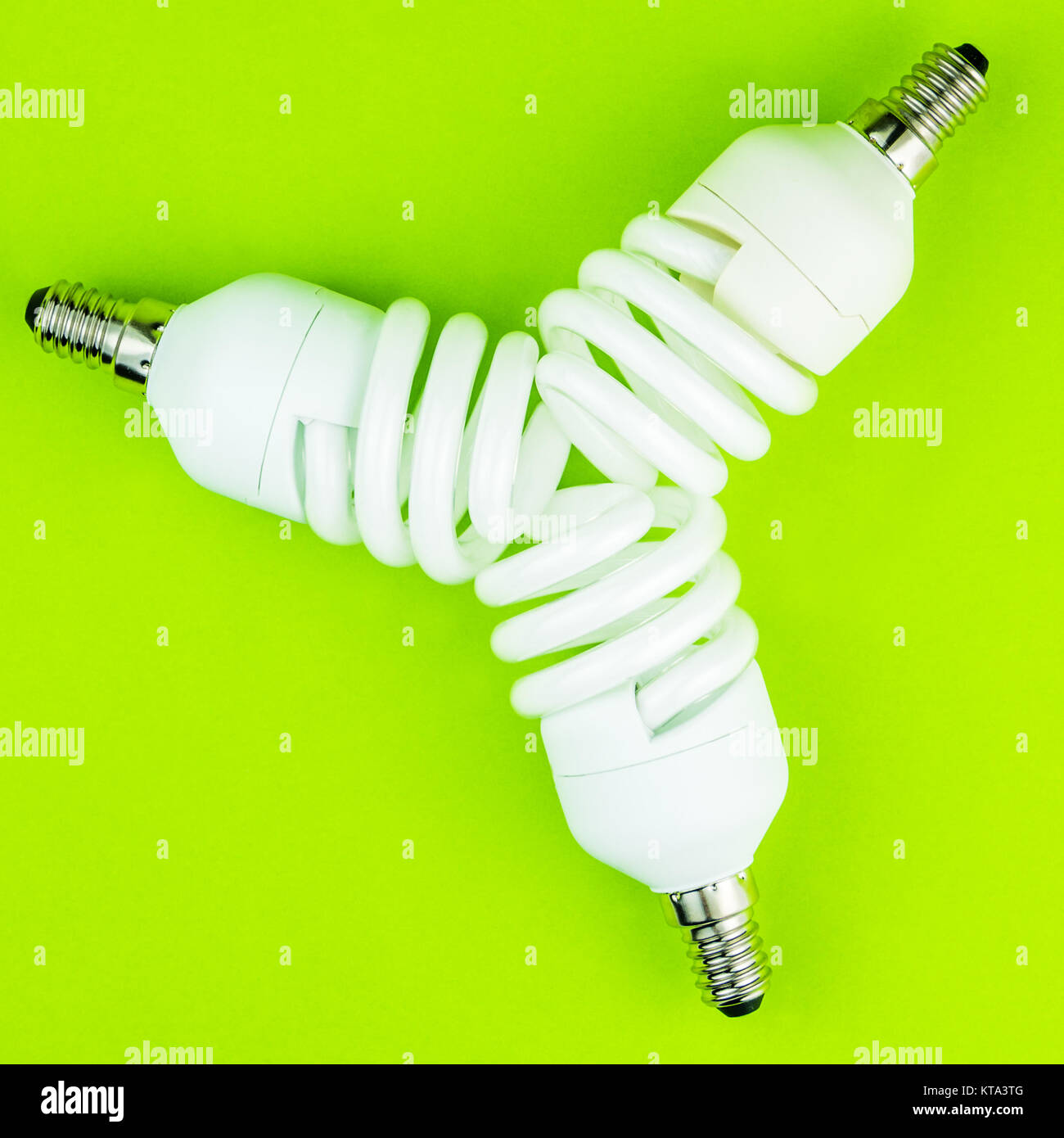 modern twisted lightbulbs on green backgound Stock Photo - Alamy