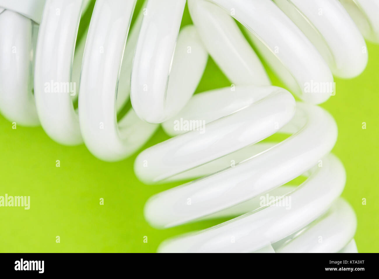 modern twisted lightbulbs on lime green backgound Stock Photo - Alamy