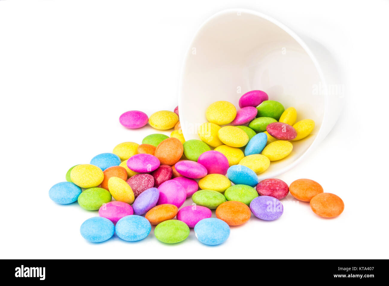 multicolored sweet choco lentils scattered on white background Stock ...