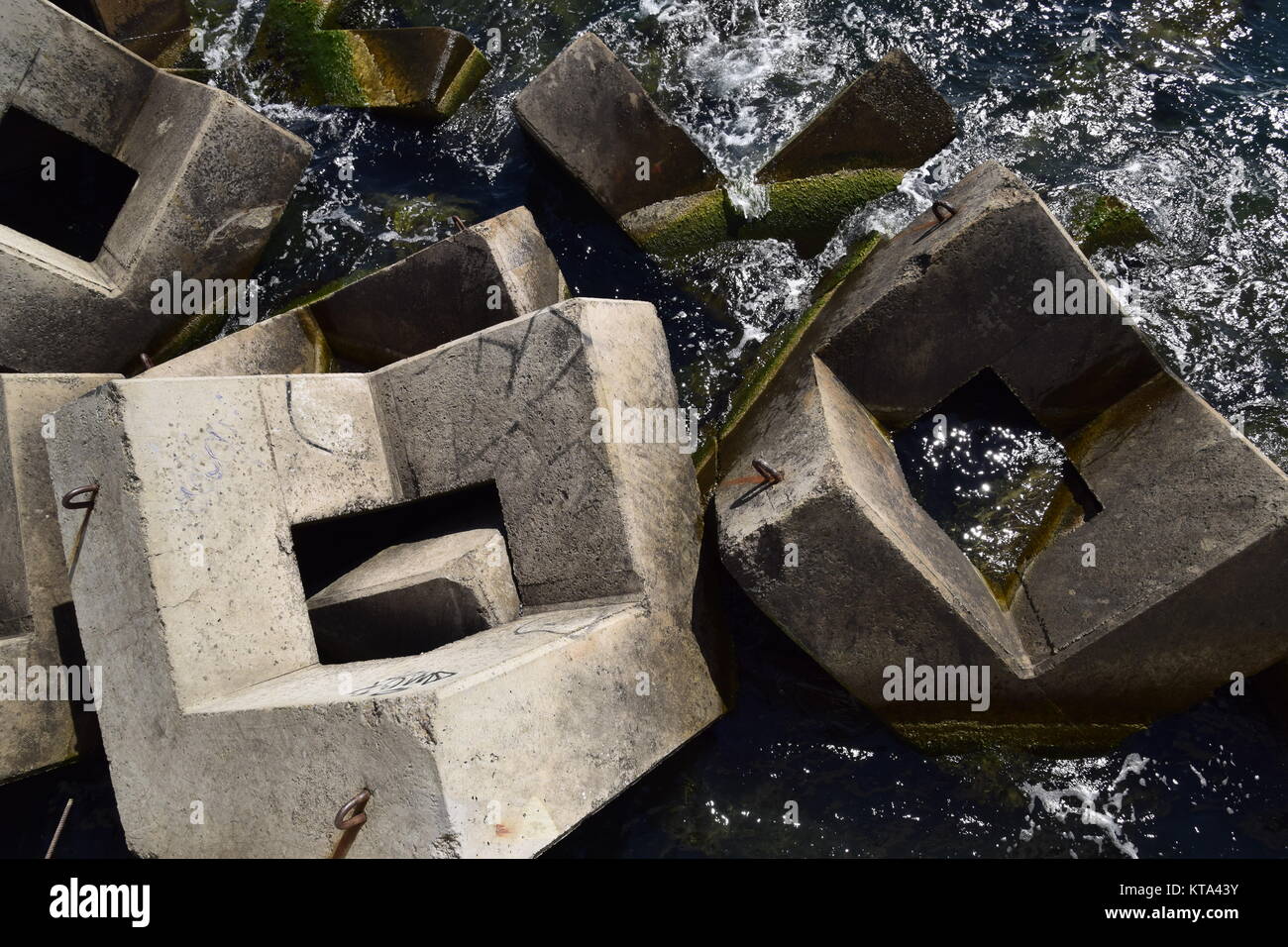Breakwater of the rectangular stone figures Stock Photo - Alamy