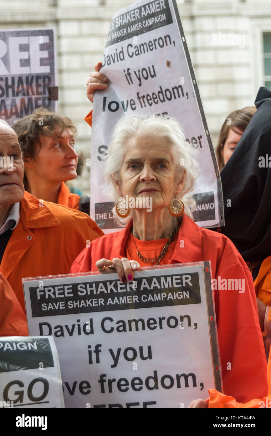 A protester holds a poster 'David Cameron if you love freedom FREE ...