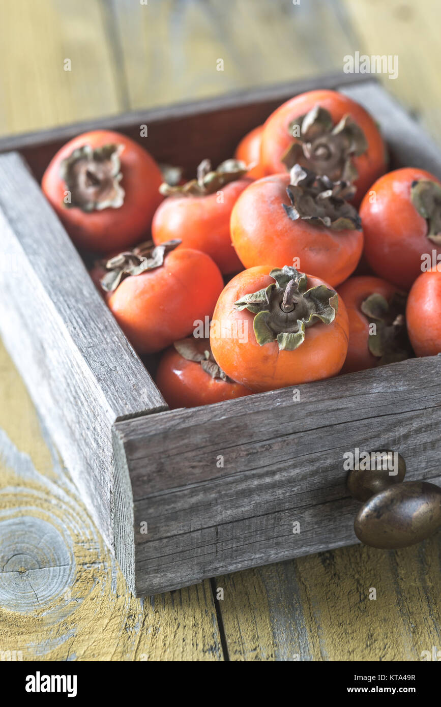 Wooden box of fresh persimmons Stock Photo - Alamy