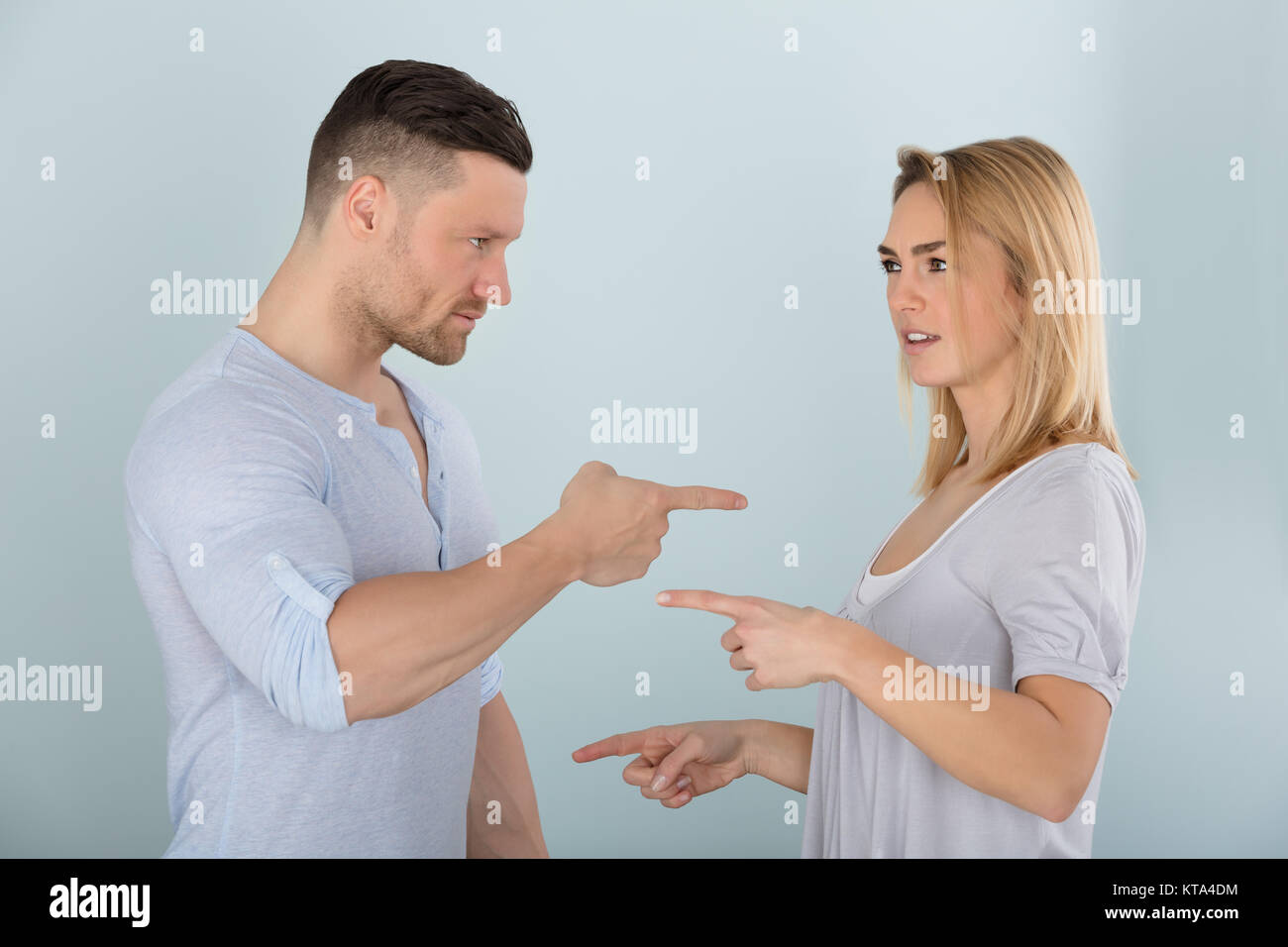 Couple Pointing At Each Other Stock Photo - Alamy