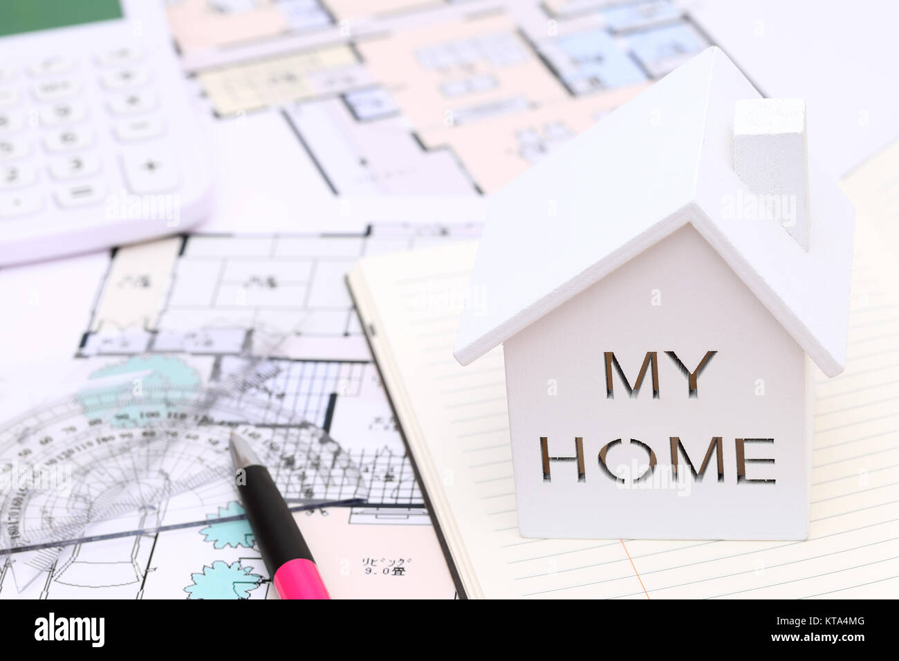 Miniature model of house on blueprints, construction plan Stock Photo ...