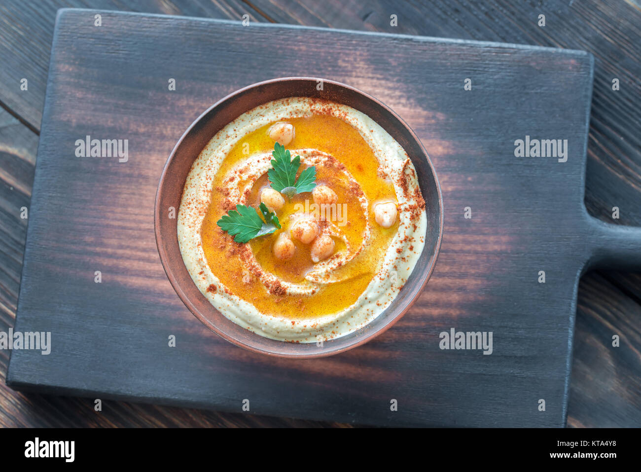 Bowl of hummus on the wooden table Stock Photo - Alamy