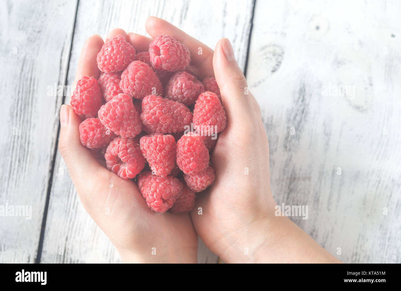Hands holding raspberries Stock Photo - Alamy